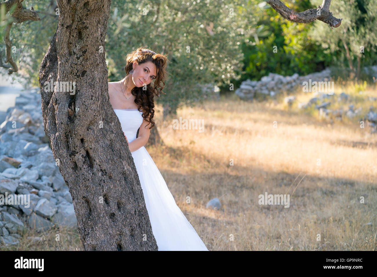 Attractive Young Woman Enjoying Her Time Outside In Olive Trees Stock