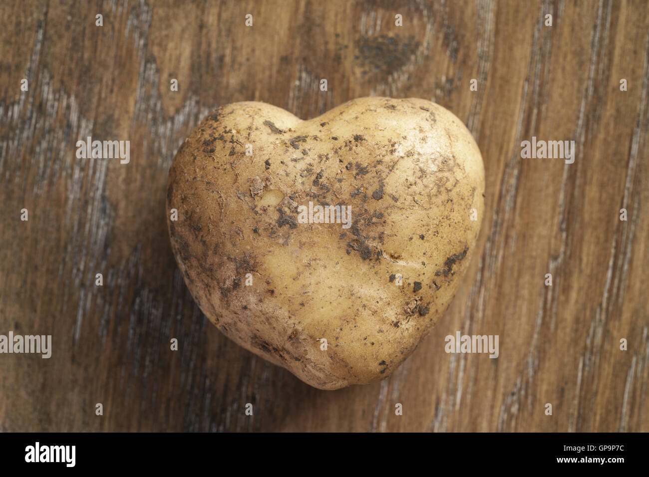 heart shaped potato on oak table Stock Photo - Alamy