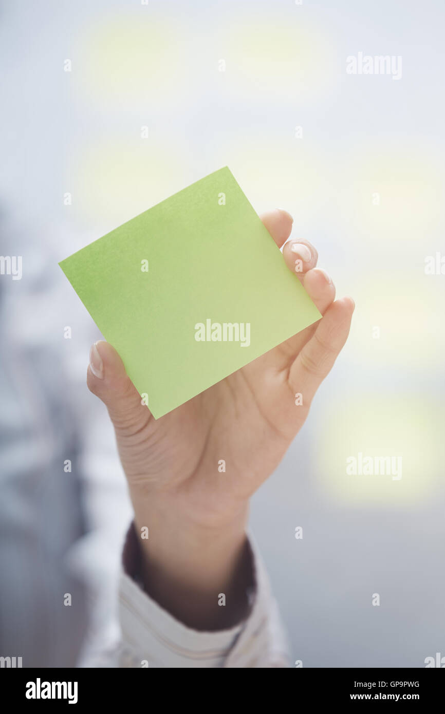 Woman holding sticky note with empty space Stock Photo - Alamy