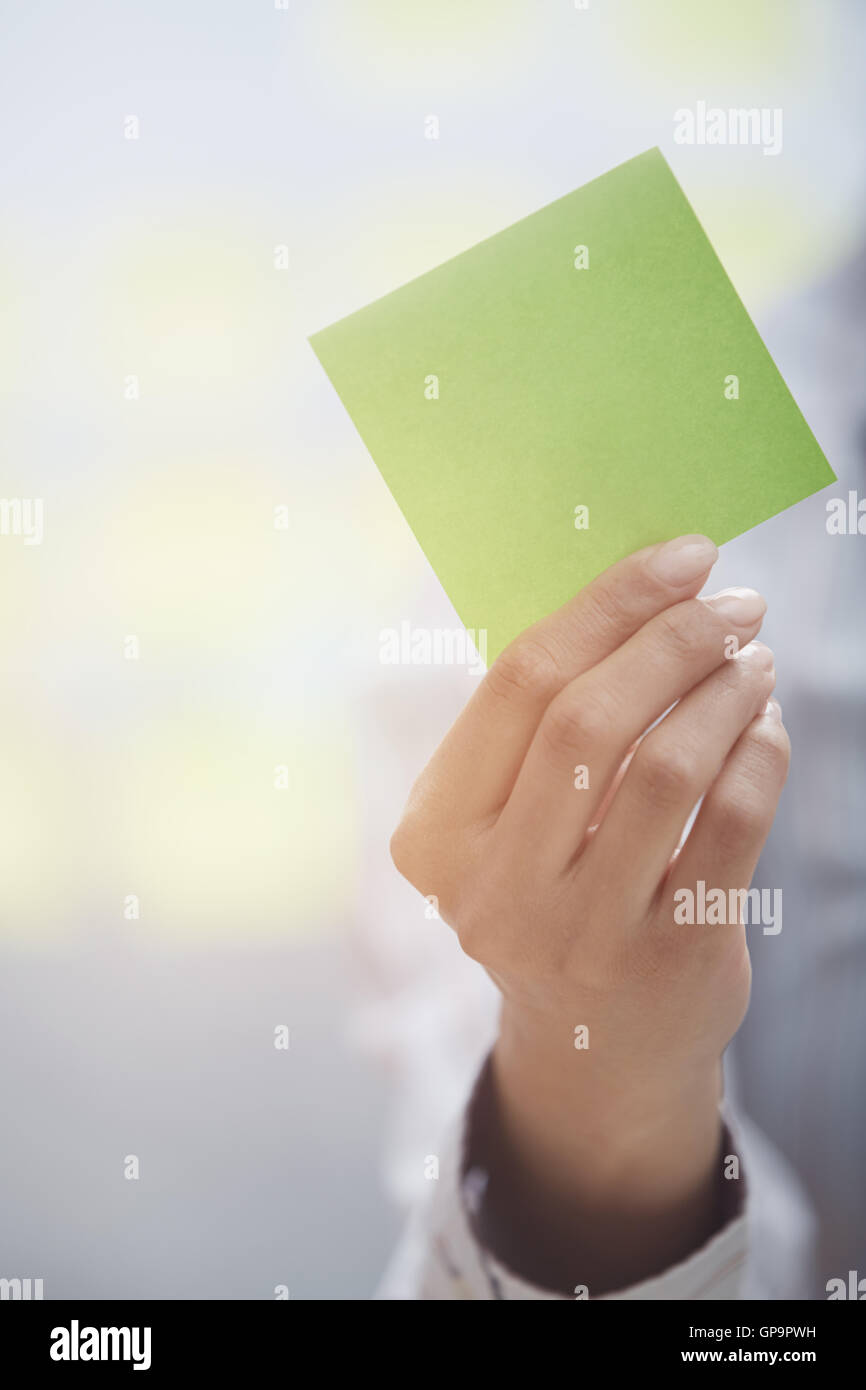 Woman holding sticky note with empty space Stock Photo - Alamy