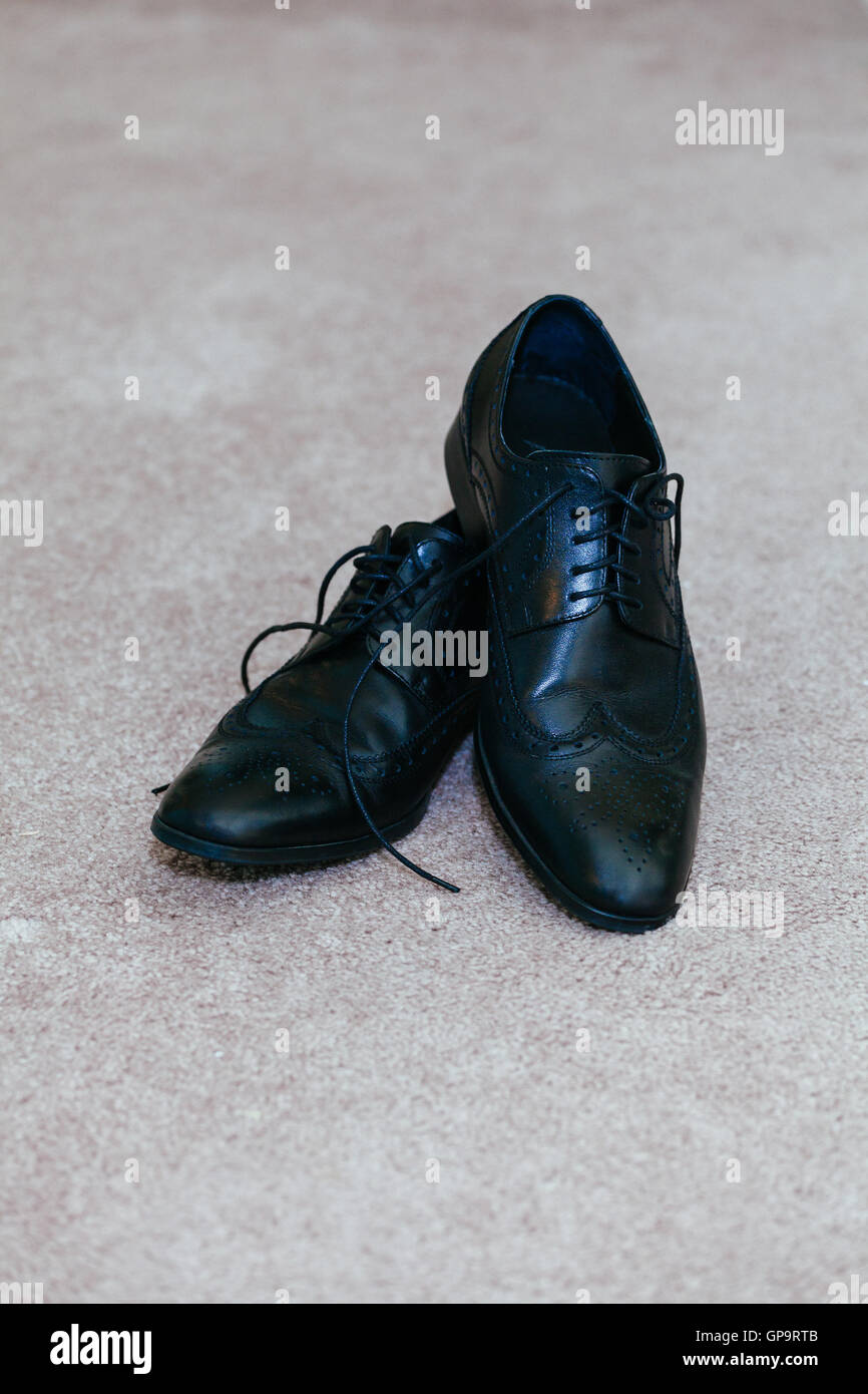 Shiny black men's shoes for the bride, lying on the floor men's shoes ...