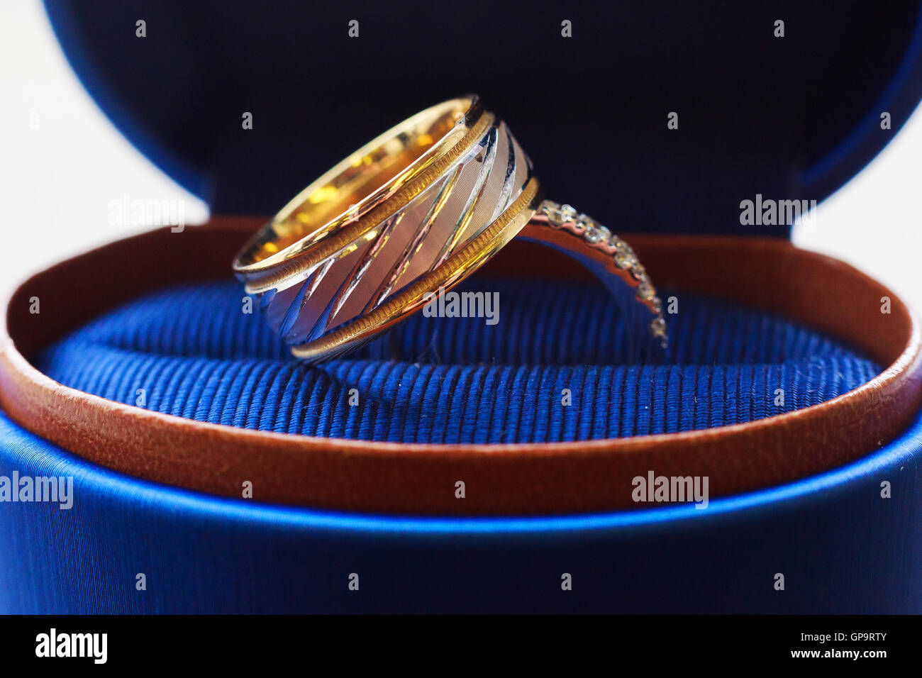 Wedding rings closeup on a pattern background Stock Photo - Alamy