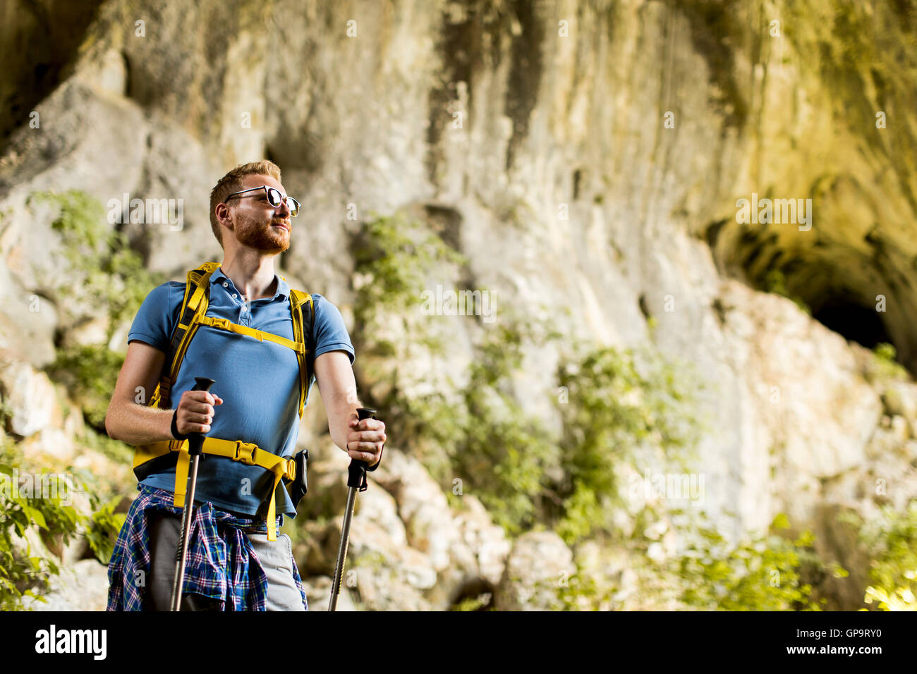 Caucasian male model with backpack hiking on sunny day Stock Photo - Alamy