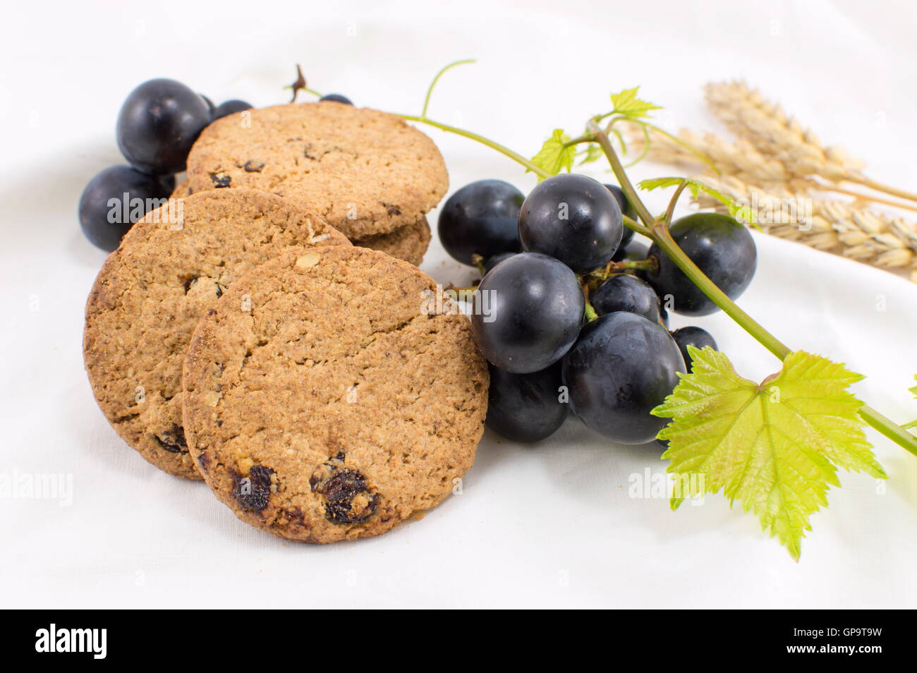 Integral cookies with grapes and wheat on white Stock Photo - Alamy