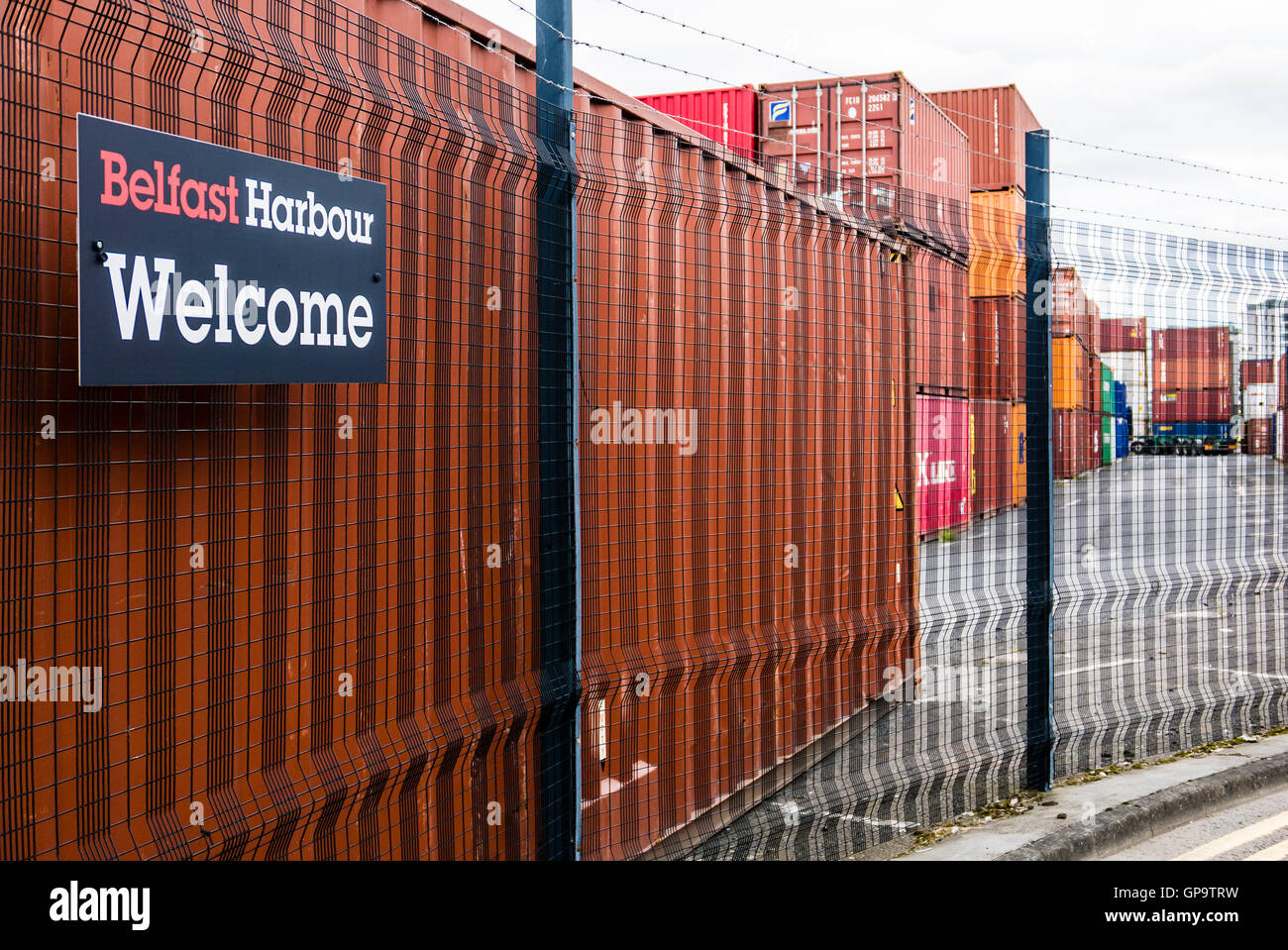 Shipping containers stacked up at Belfast Harbour, behind a security ...