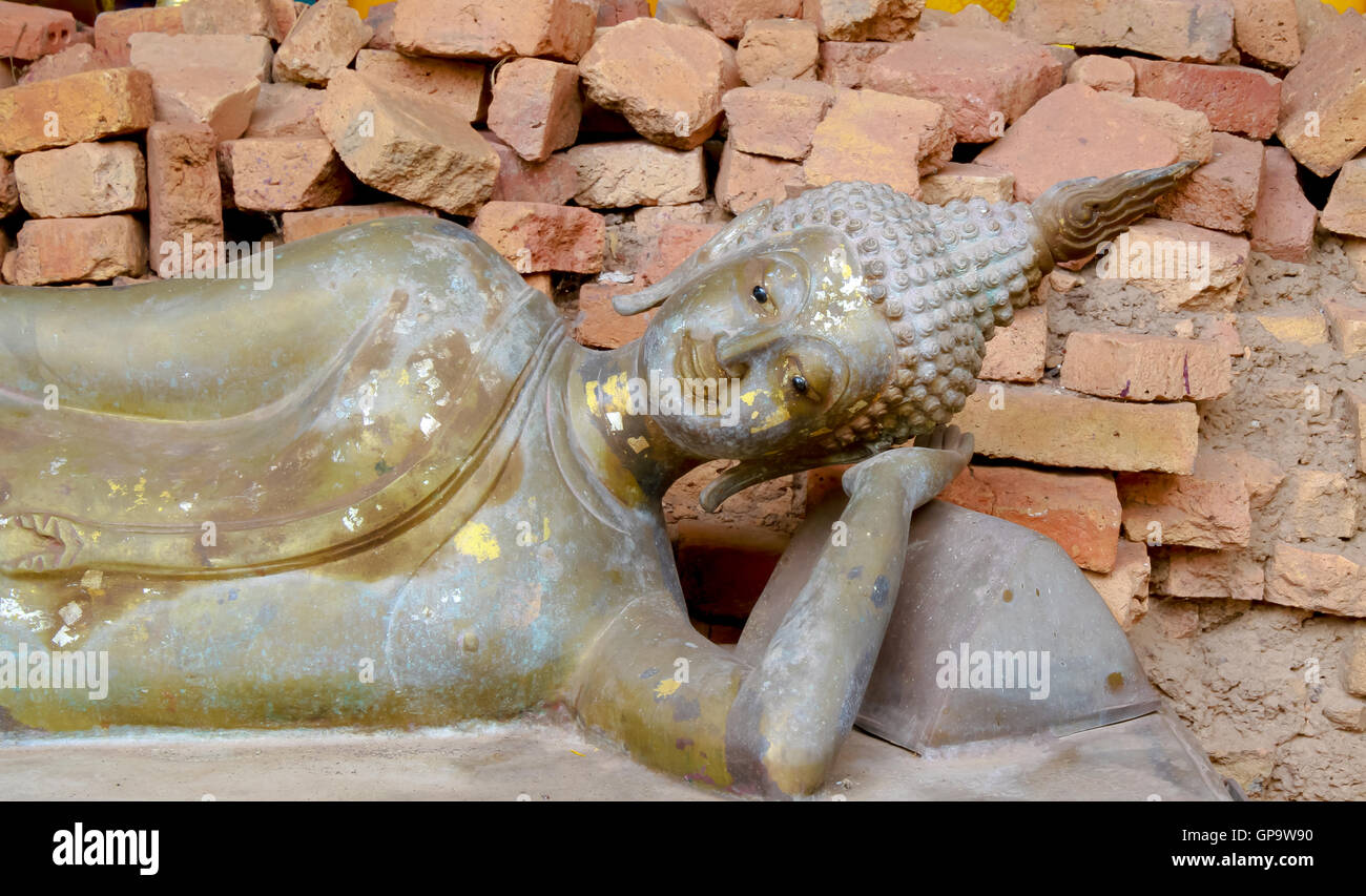 reclining Buddha with brick wall background Stock Photo - Alamy