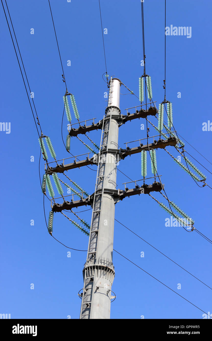 Vertical power lines on blue sky background Stock Photo - Alamy