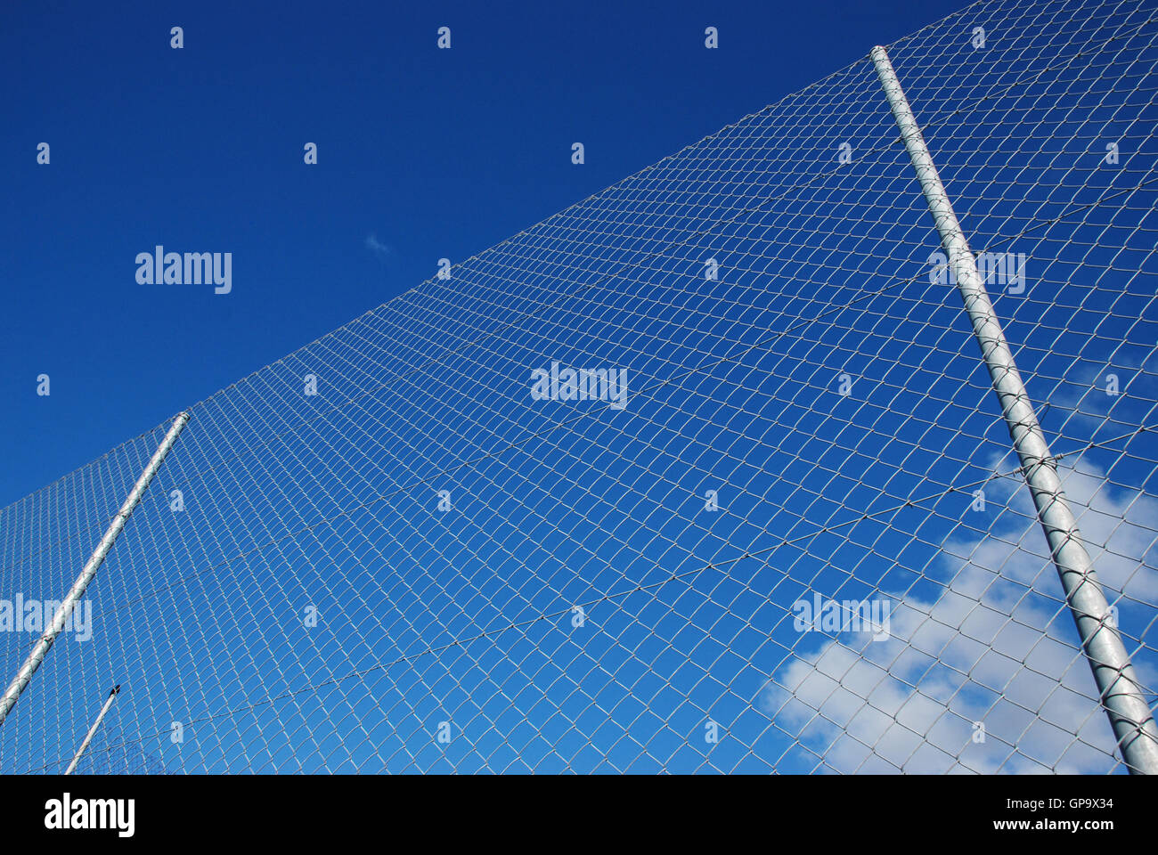 A barrier of fence netting against the sky Stock Photo - Alamy
