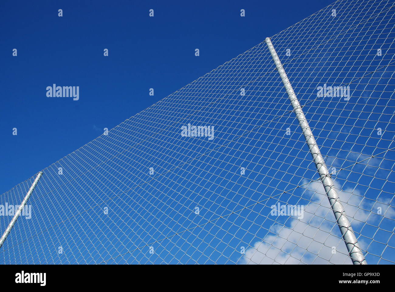 A barrier of fence netting against the sky Stock Photo - Alamy