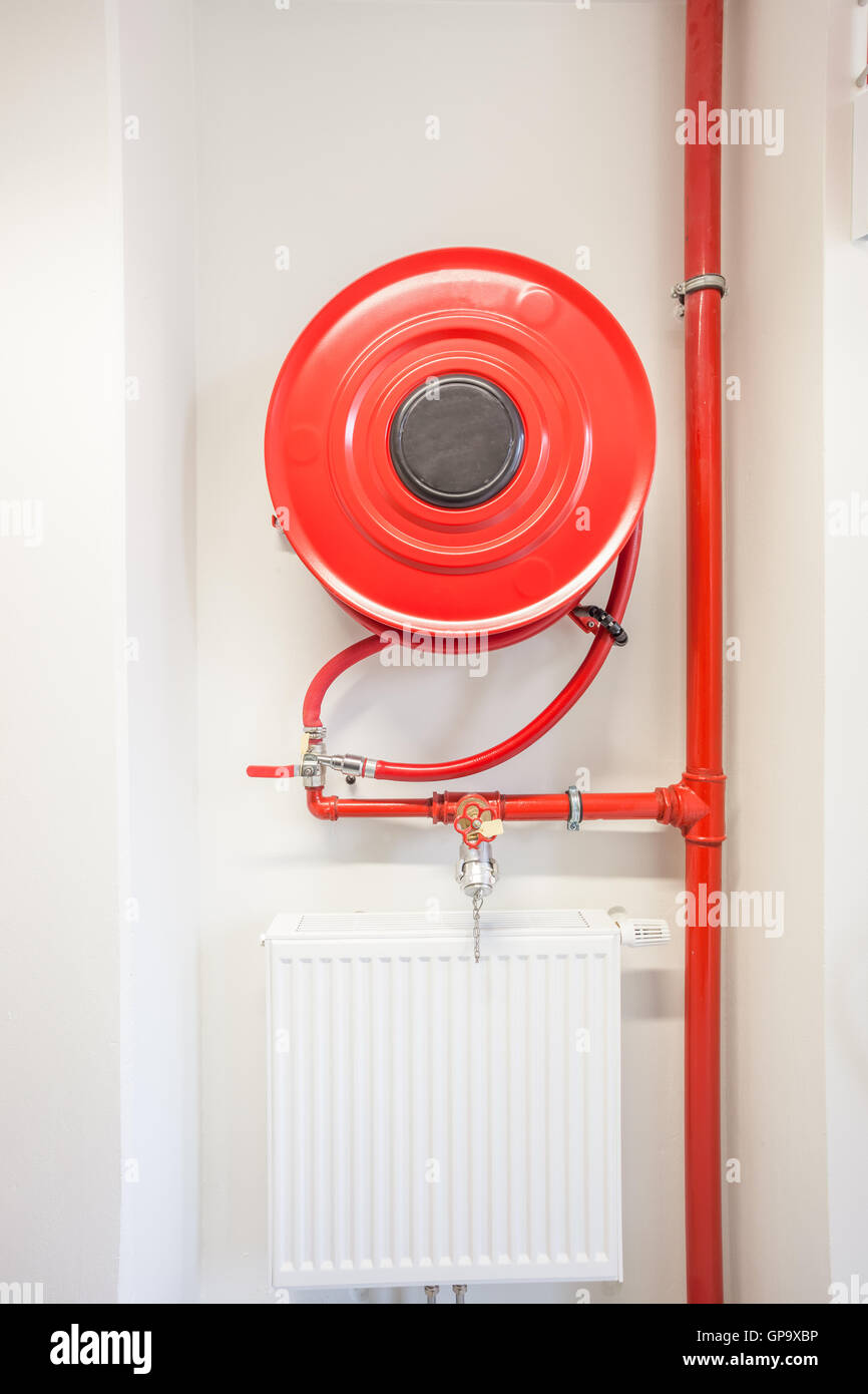 an fire hose hanging on the wall in an staircase Stock Photo - Alamy