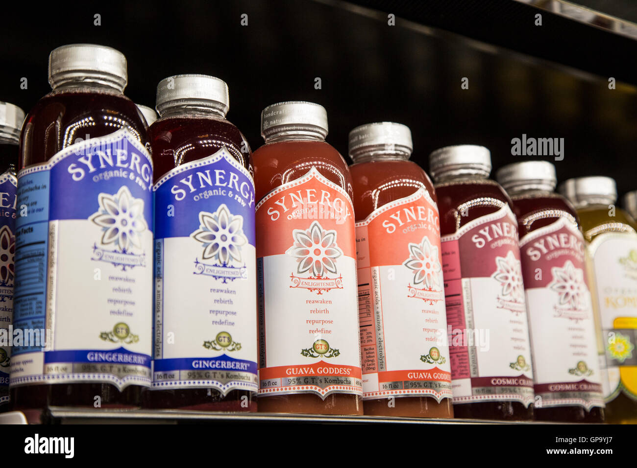 A shelf with bottles of GT Synergy brand Kombucha on display at a ...
