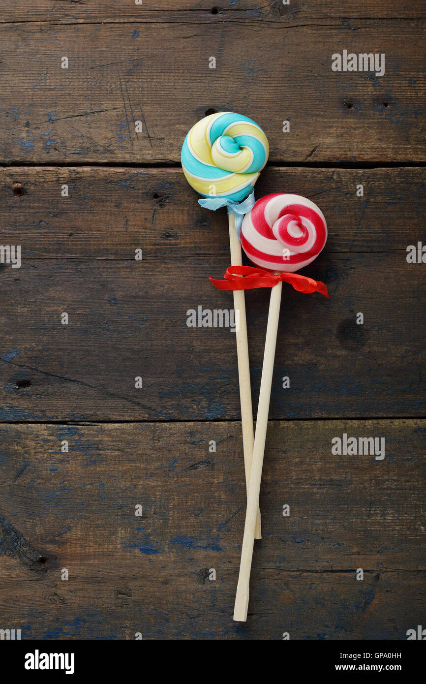 Small lollipop on wood, candy above Stock Photo - Alamy