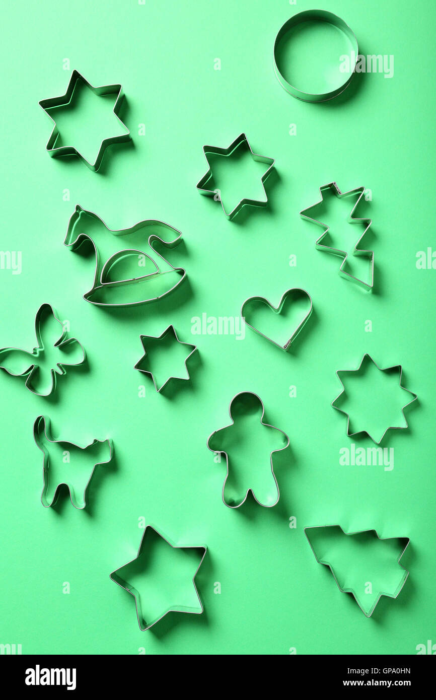 Cookies cutters on green background, food pattern Stock Photo - Alamy