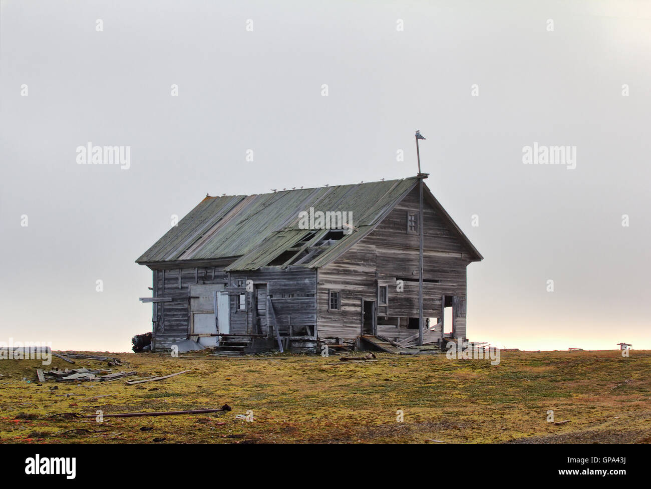 wooden hunting Lodge in open tundra, partially destroyed by hurricane ...