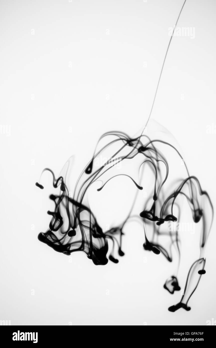 Black ink flowing through water, with vignette Stock Photo - Alamy