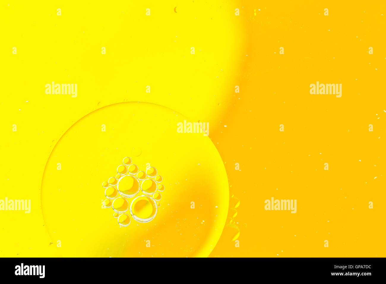 Large circular drops of oil floating on water Stock Photo - Alamy