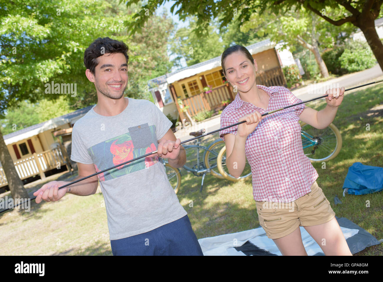 couple camping with the rods Stock Photo - Alamy