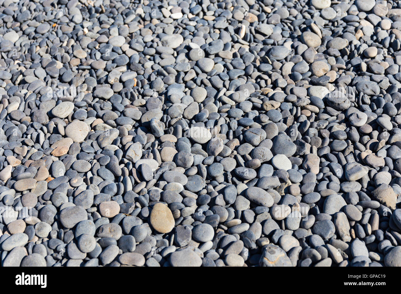 Volcanic pebble stone background on Mavra Volia volcano gravel beach in ...
