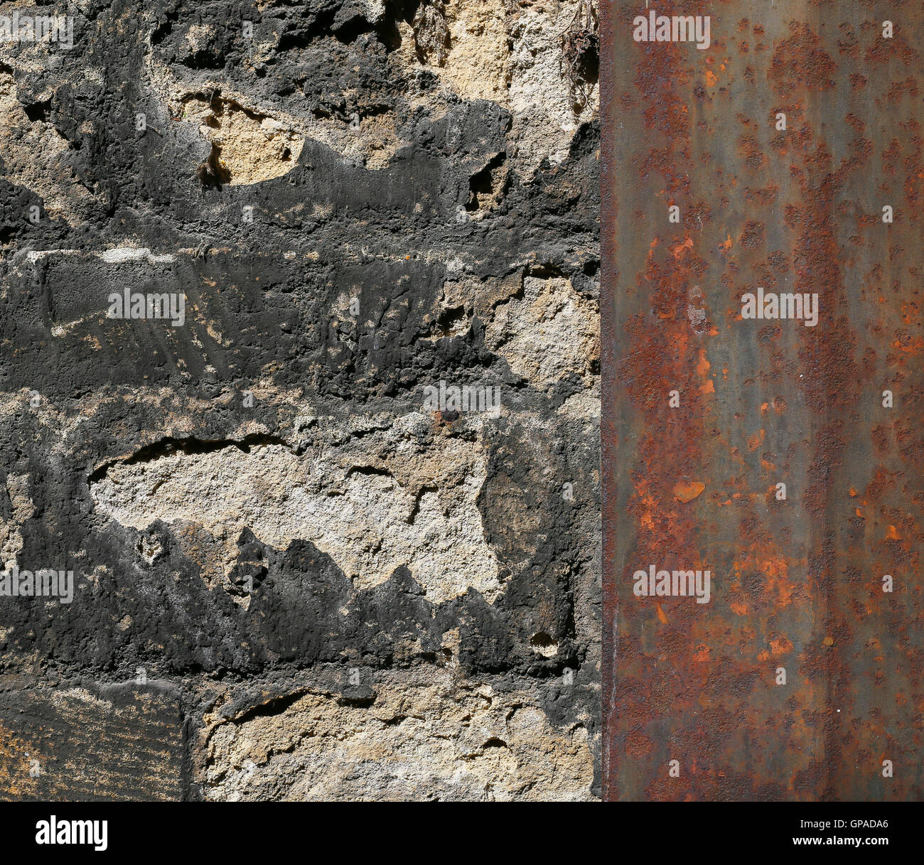 Old stone wall reinforced with metal plates closeup architectural ...