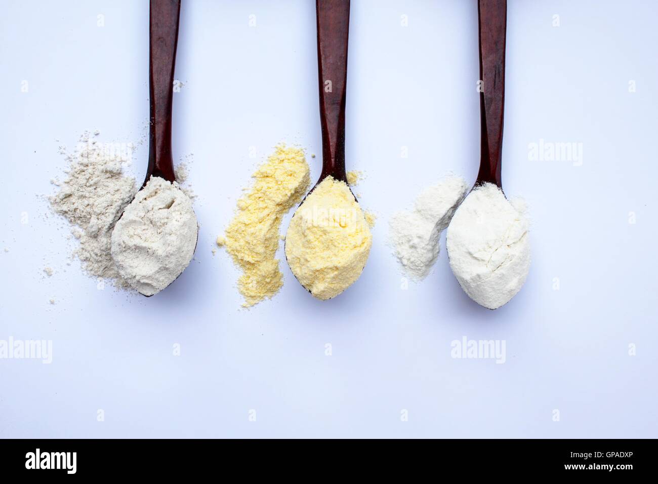 Three types of flour in wooden spoons Stock Photo - Alamy