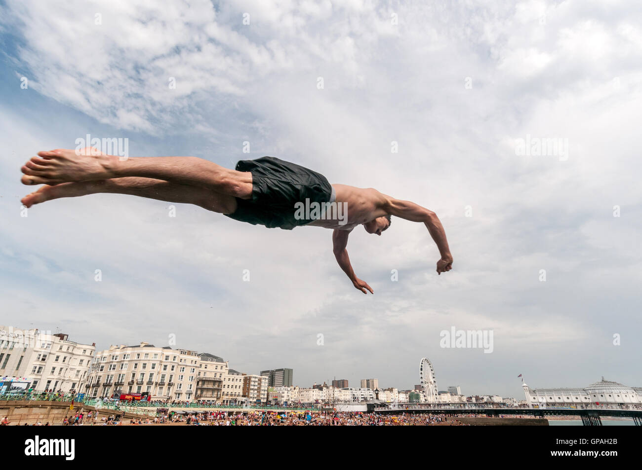Teenagers diving and jumping into the sea from a groyne on Brighton ...