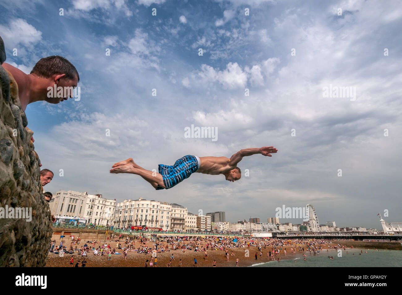 Teenagers diving and jumping into the sea from a groyne on Brighton ...