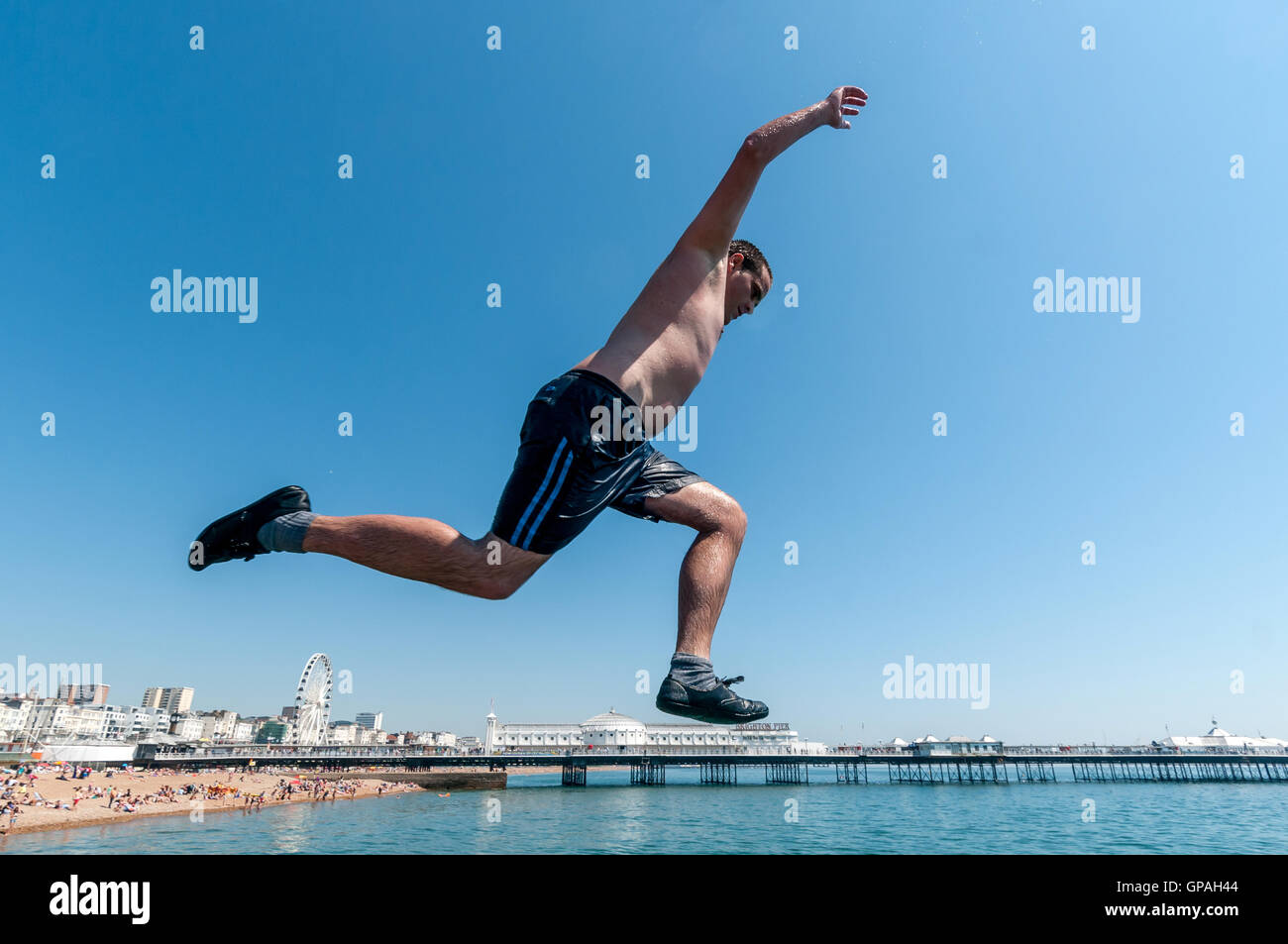 Teenagers diving and jumping into the sea from a groyne on Brighton ...
