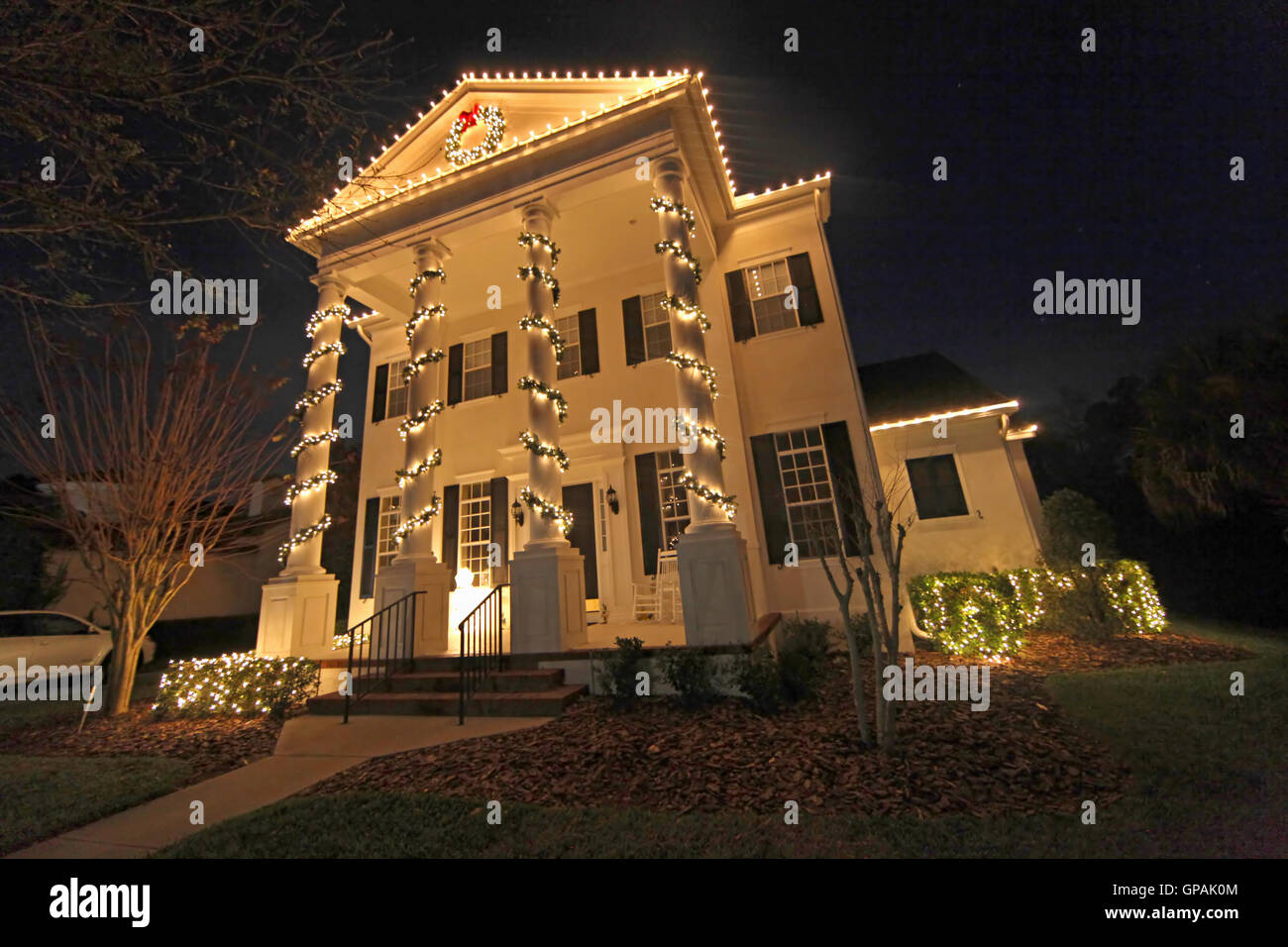 A Colonial House with a lot of Christmas Lights Stock Photo - Alamy