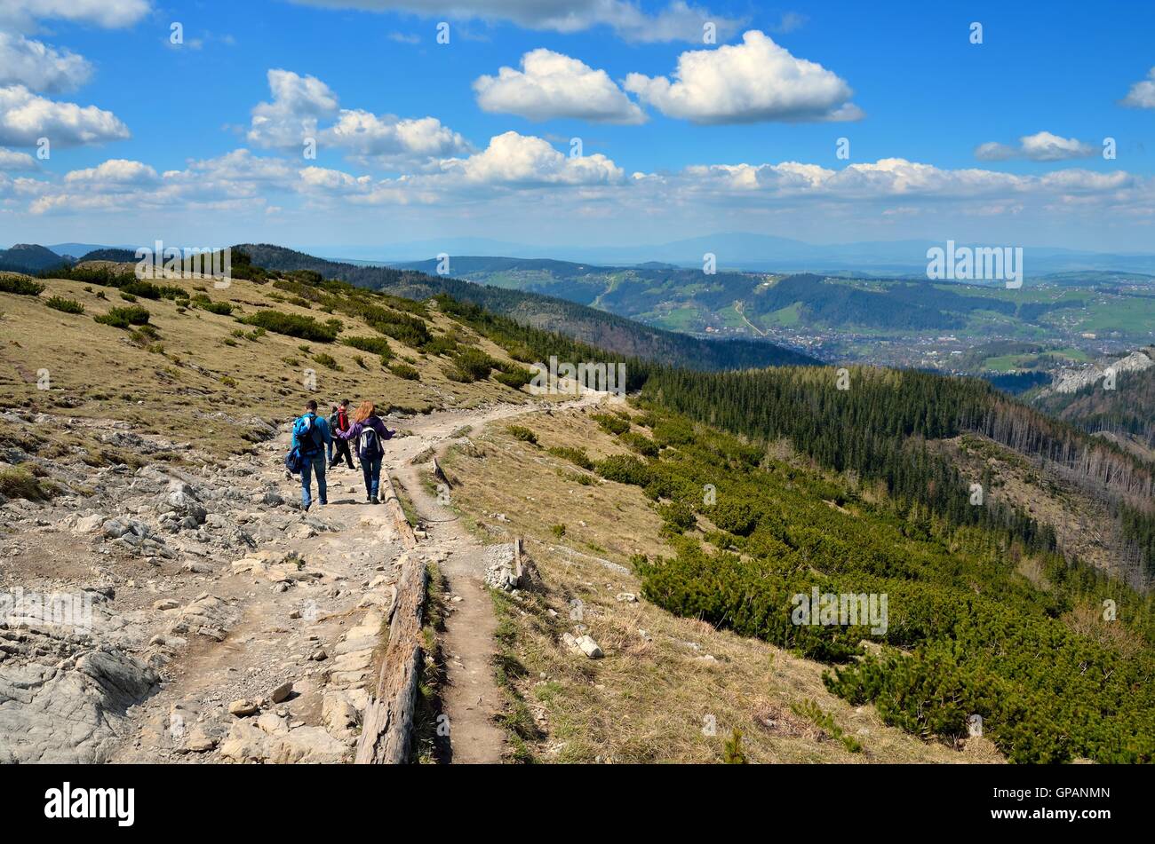 Spring mountain landscape. Tourists on the mountain trail in High Tatra ...