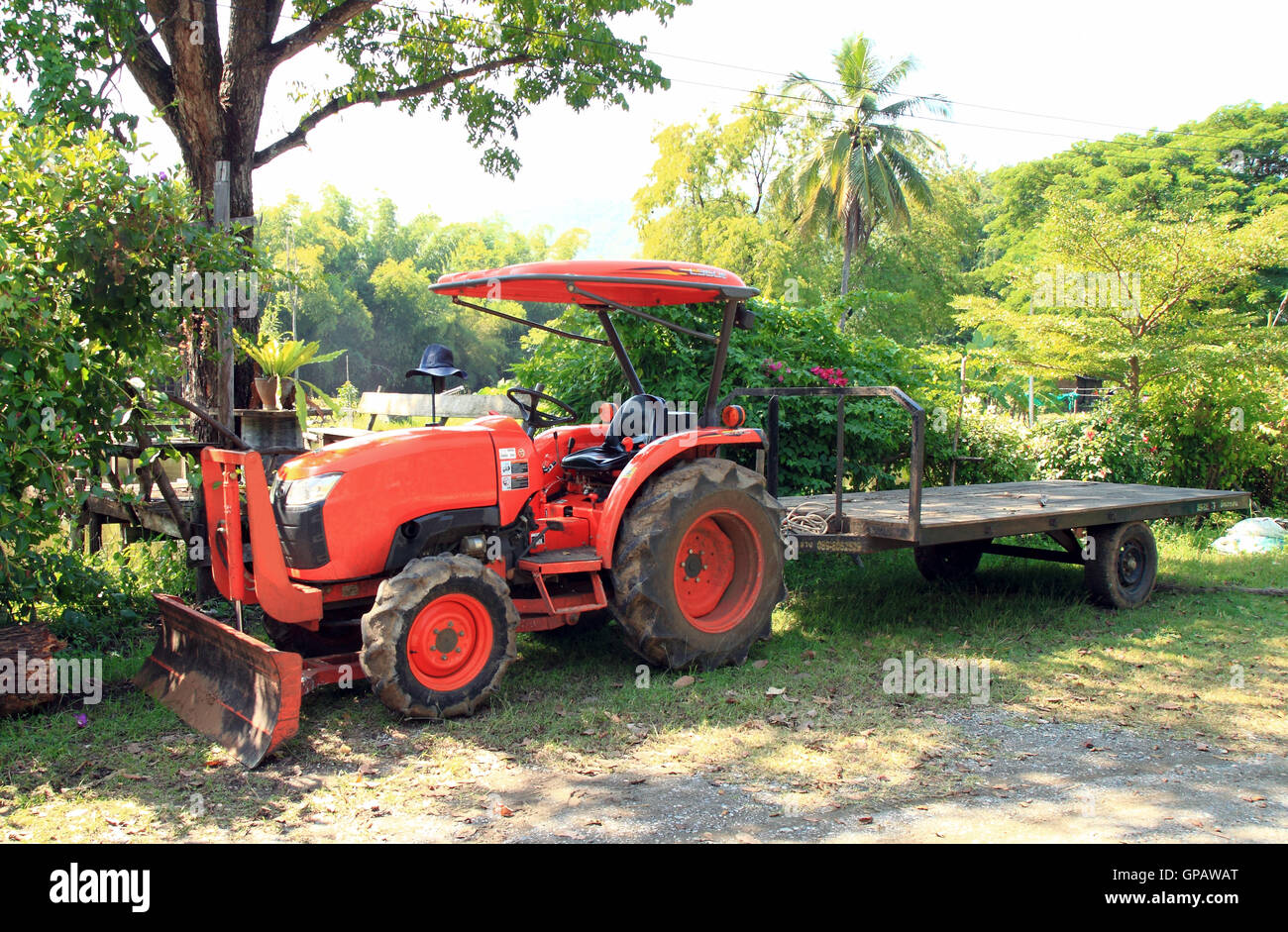 Red tractor with trailer Stock Photo - Alamy