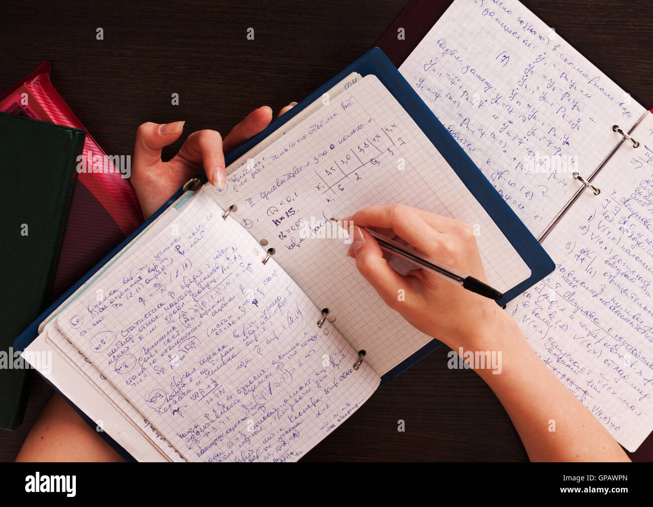 Student hands holding notebook and pen Stock Photo - Alamy