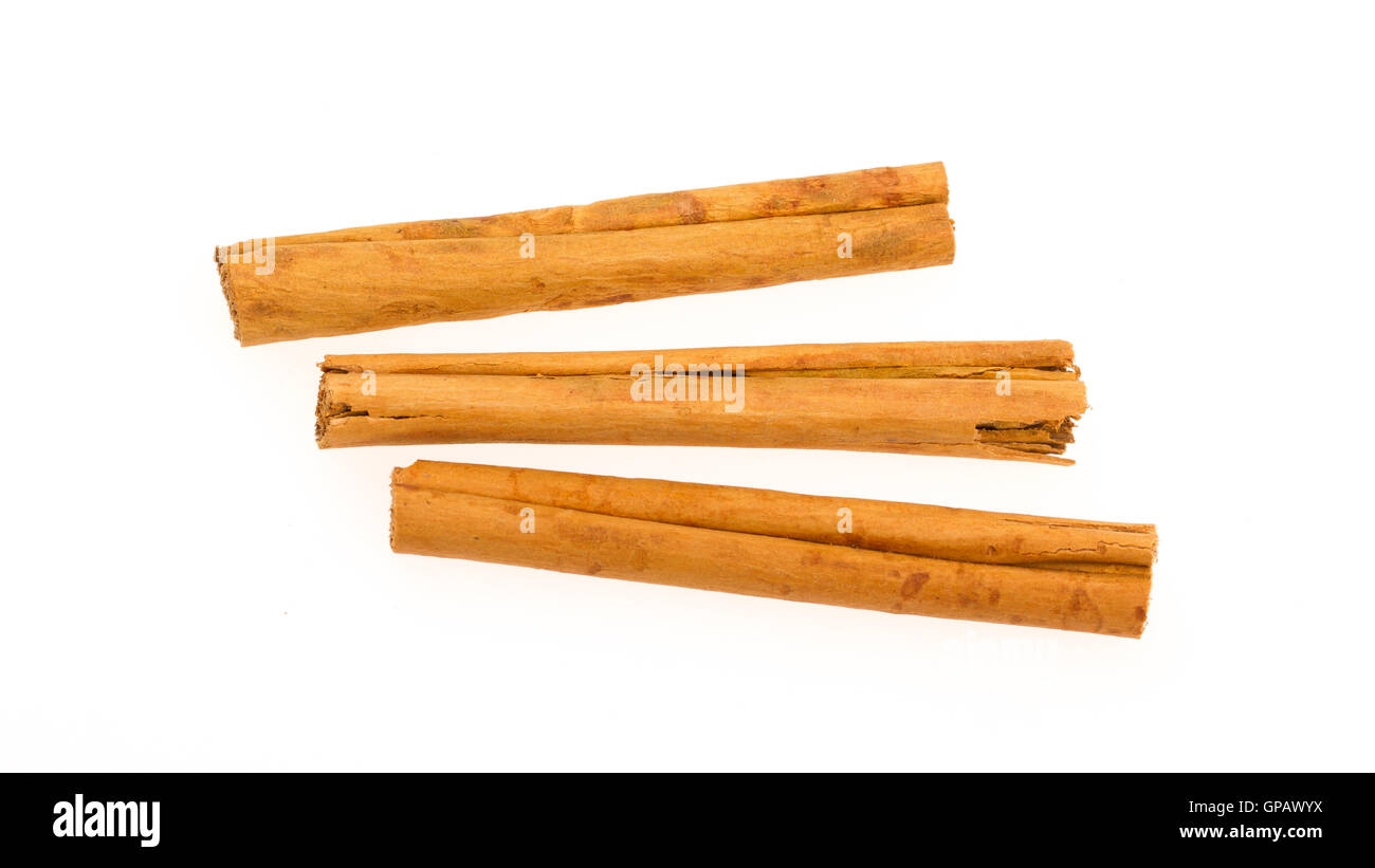 Three cinnamon sticks isolated on white background Stock Photo - Alamy