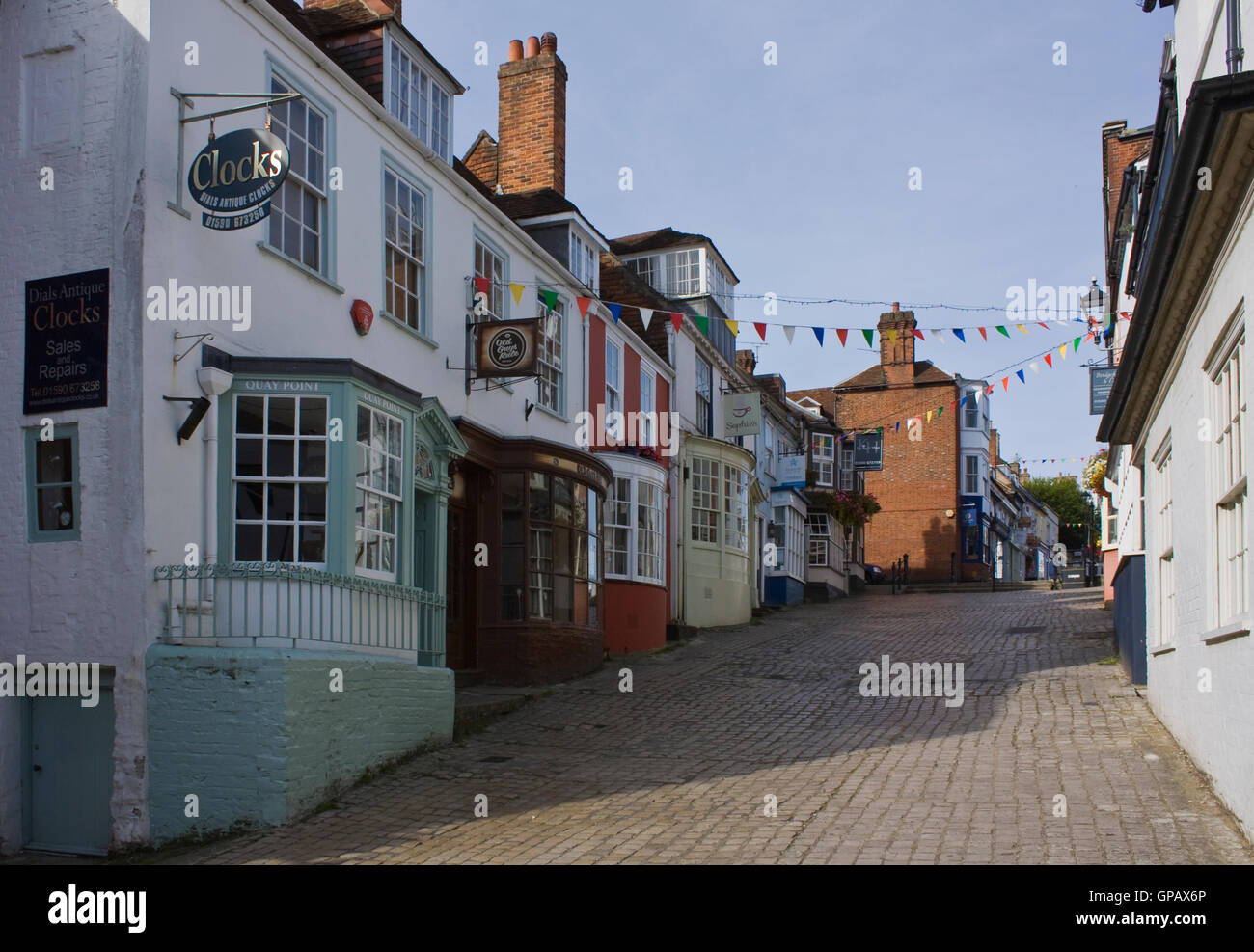 Cobbled Street traditional bay windowed shops sunny morning sea side ...