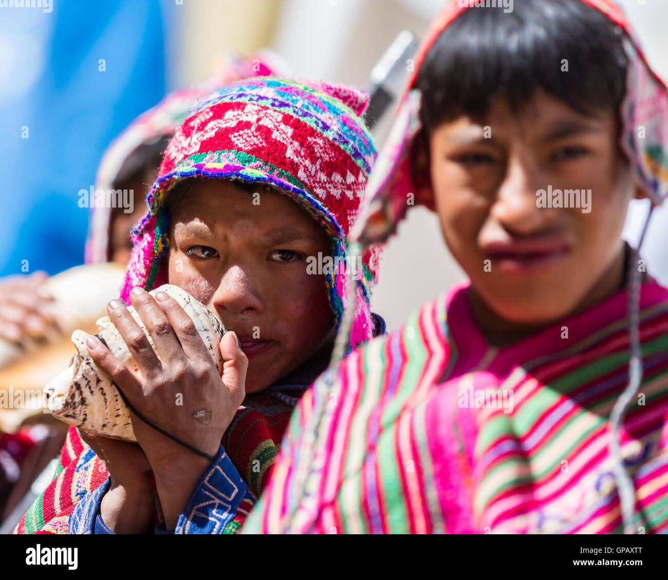 Pisac, Peru - May 15: Young man playing a tune using a conch shell as ...