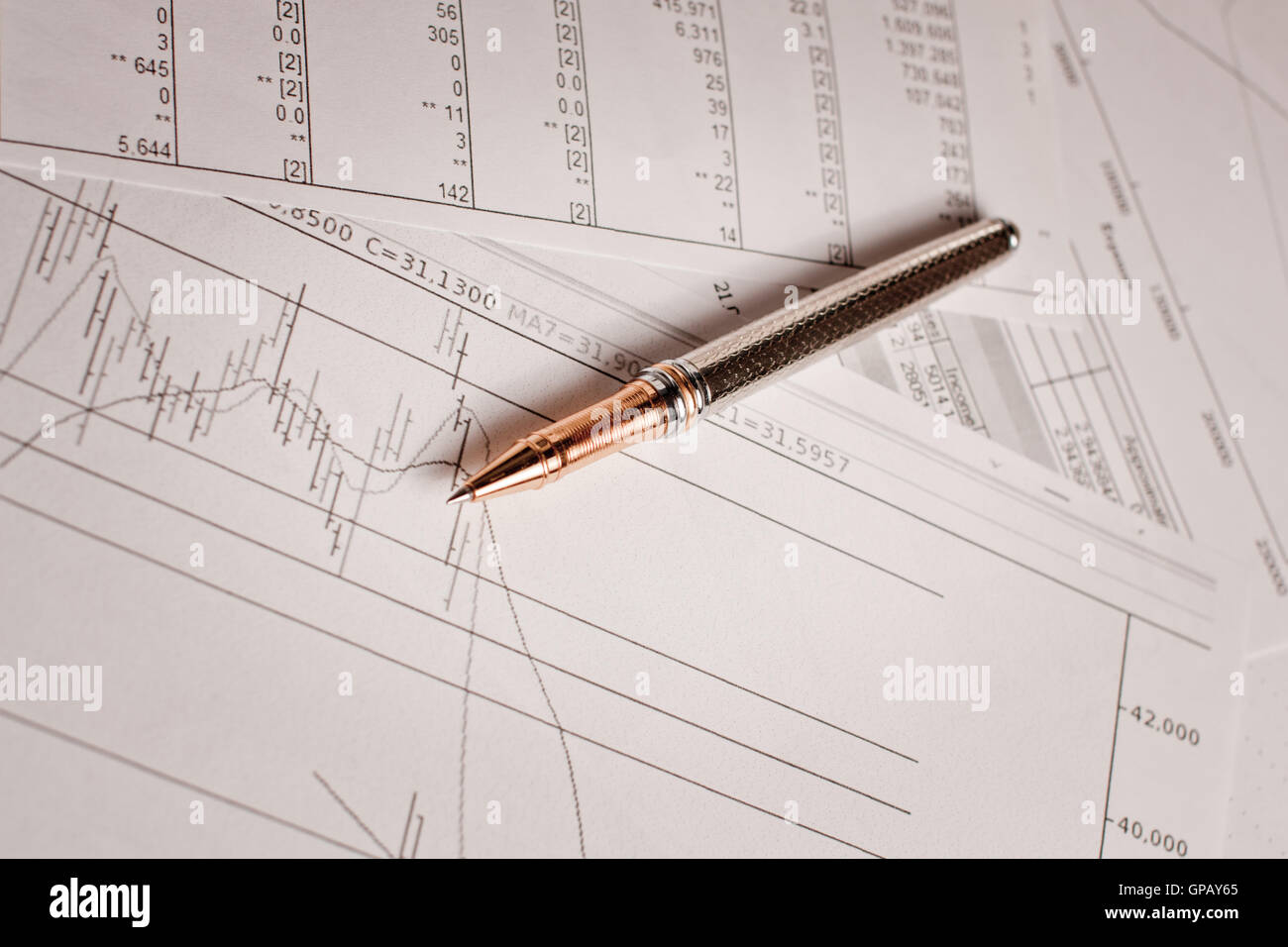 Pen and financial charts Stock Photo - Alamy