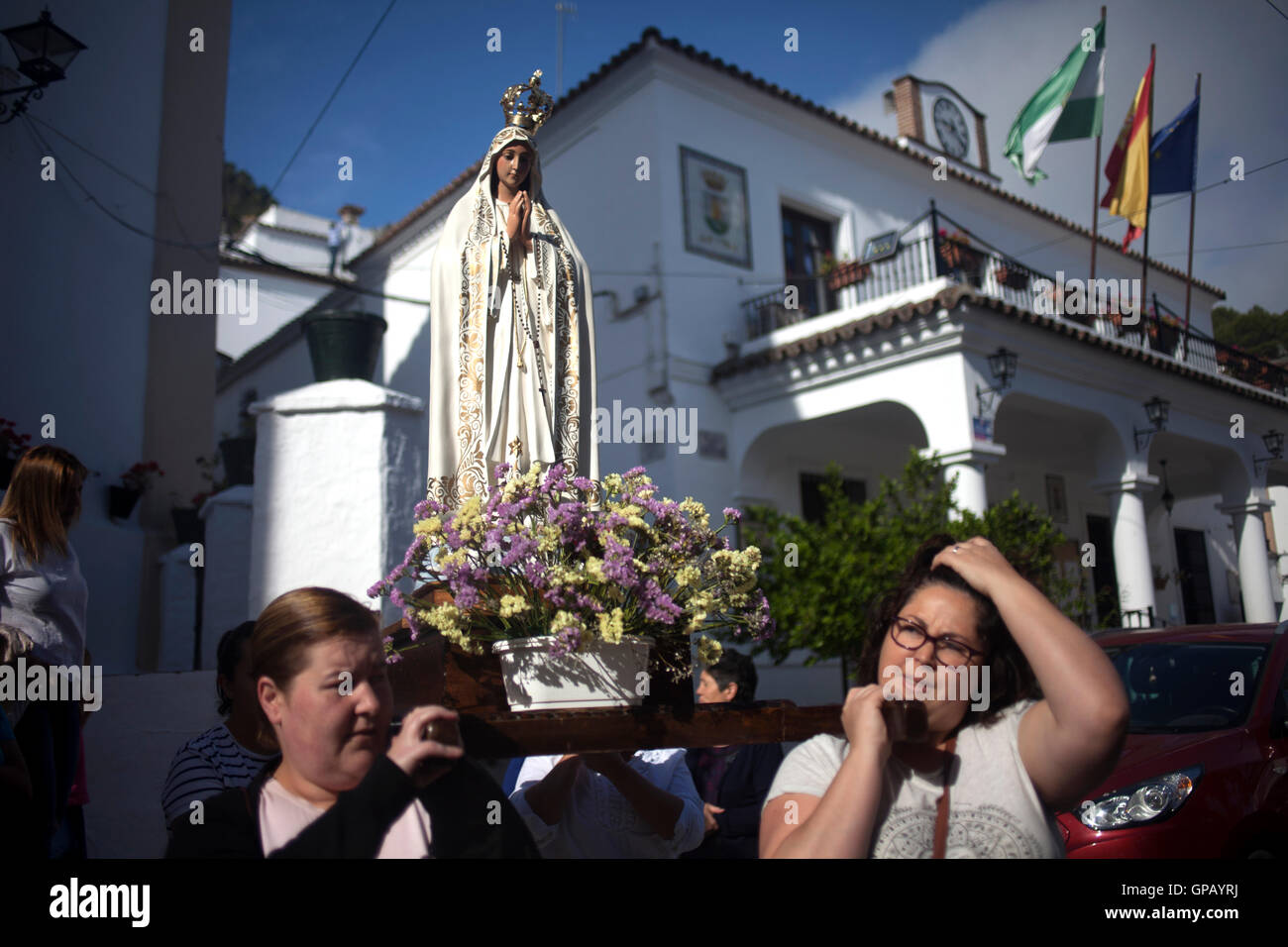 Women carry an image of Our Lady of Fatima displayed during a religious ...