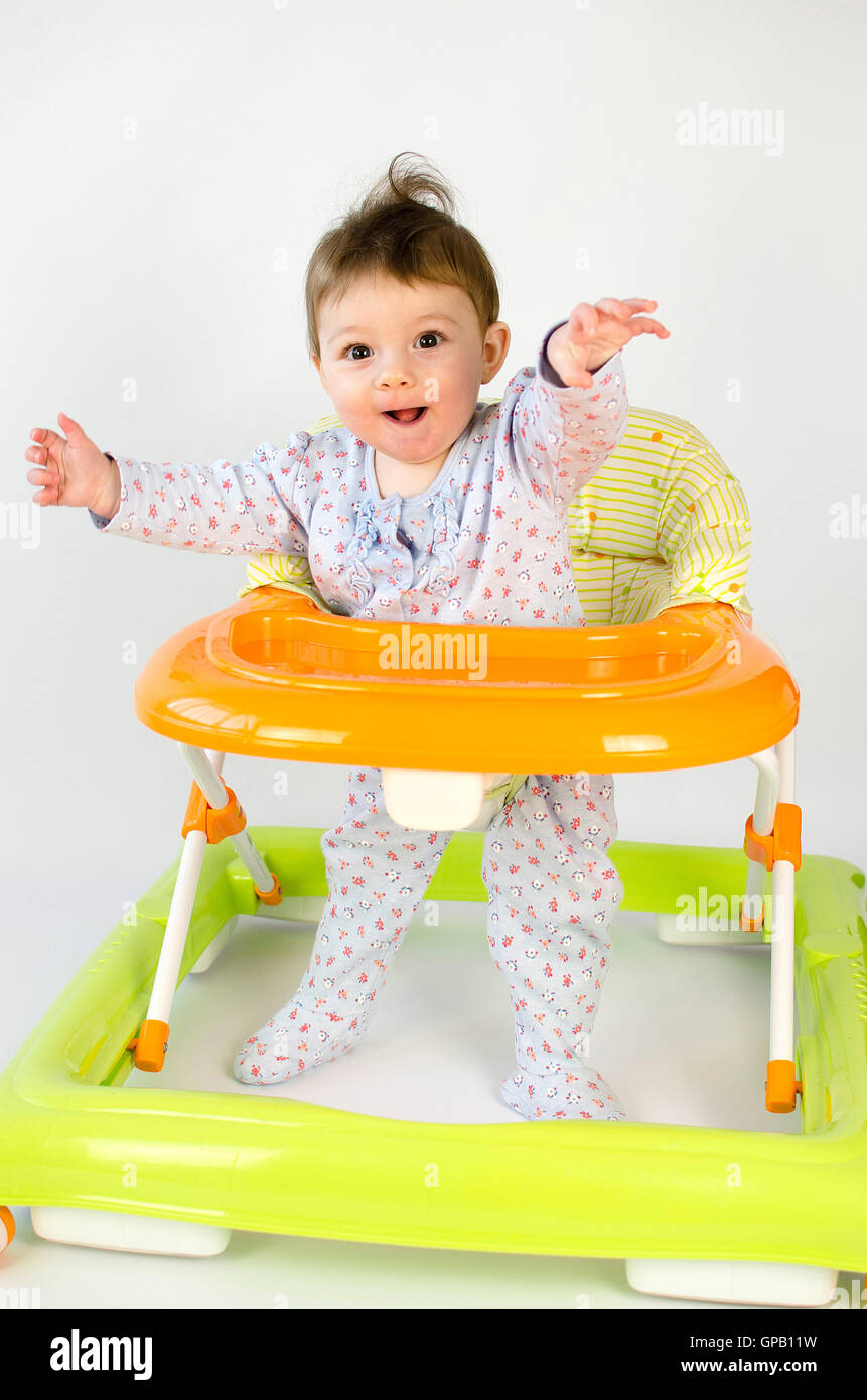 adorable happy baby girl sitting in a walker Stock Photo - Alamy