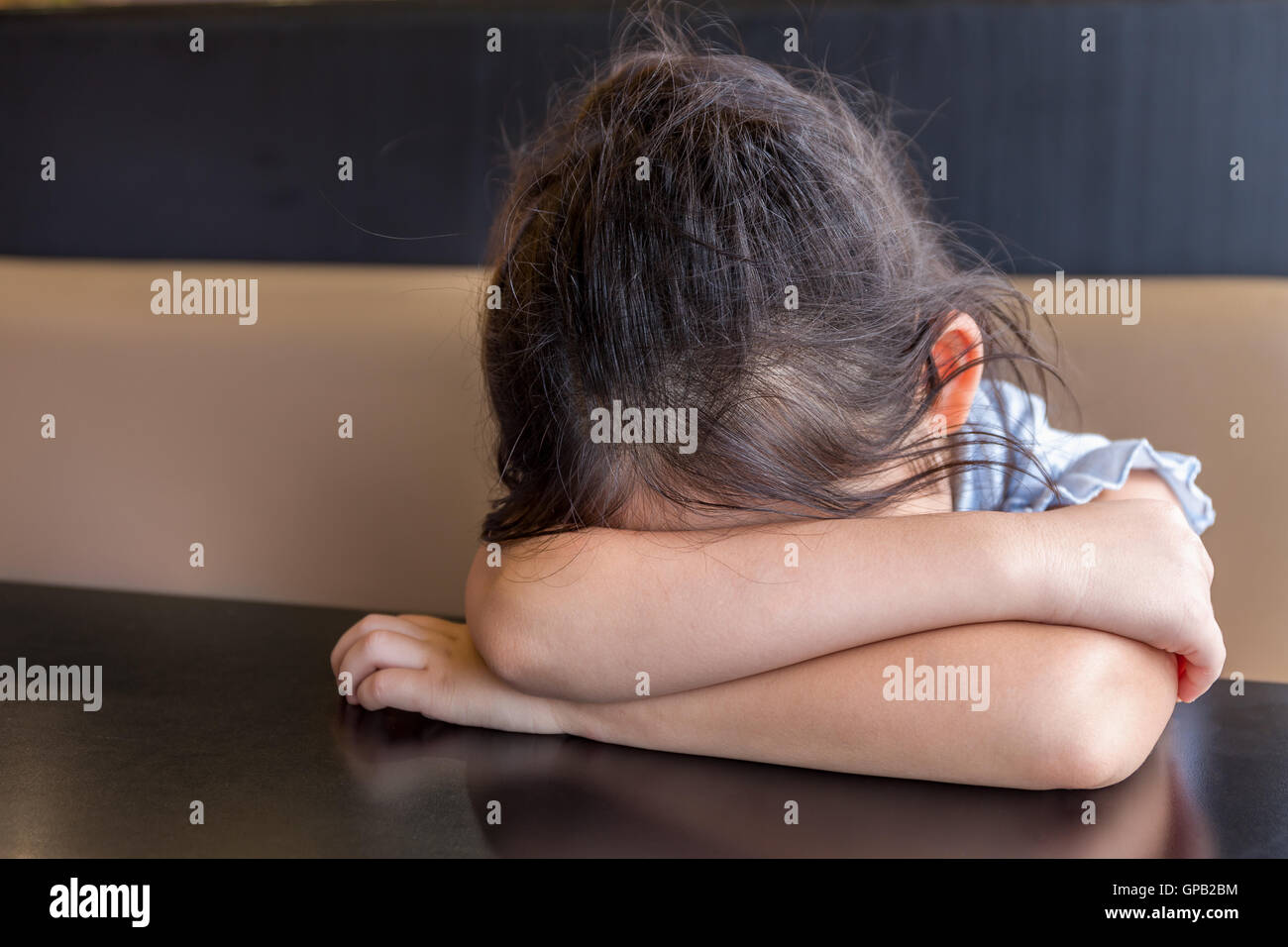 Tired child sleeping on desk or table Stock Photo - Alamy