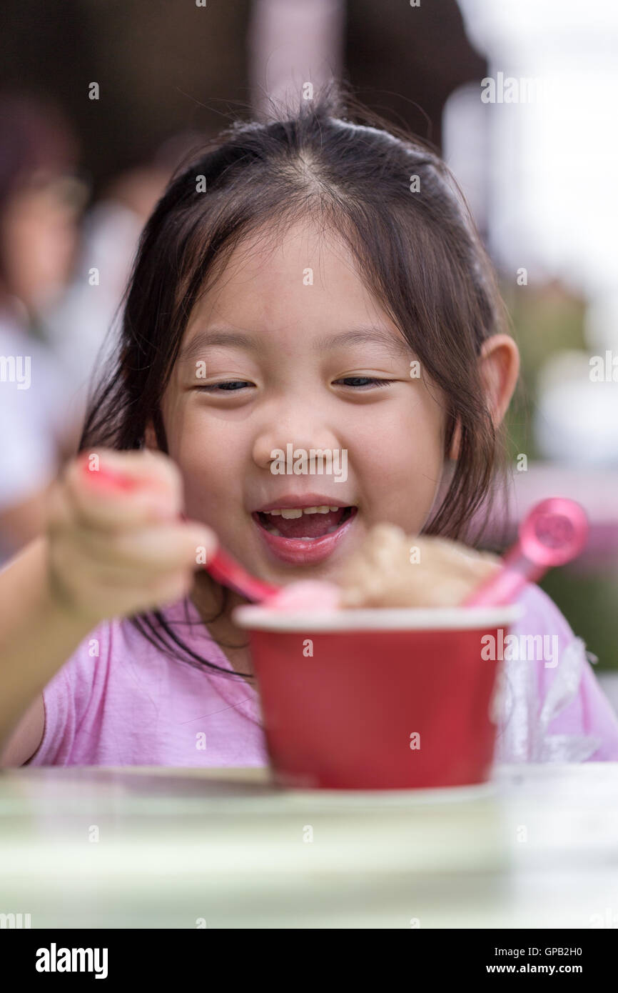 Child eating ice cream with happy face Stock Photo - Alamy