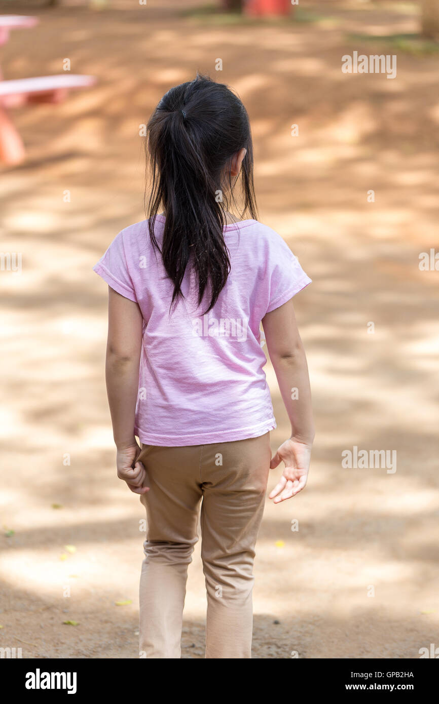 Back view of lonely child in playground Stock Photo - Alamy