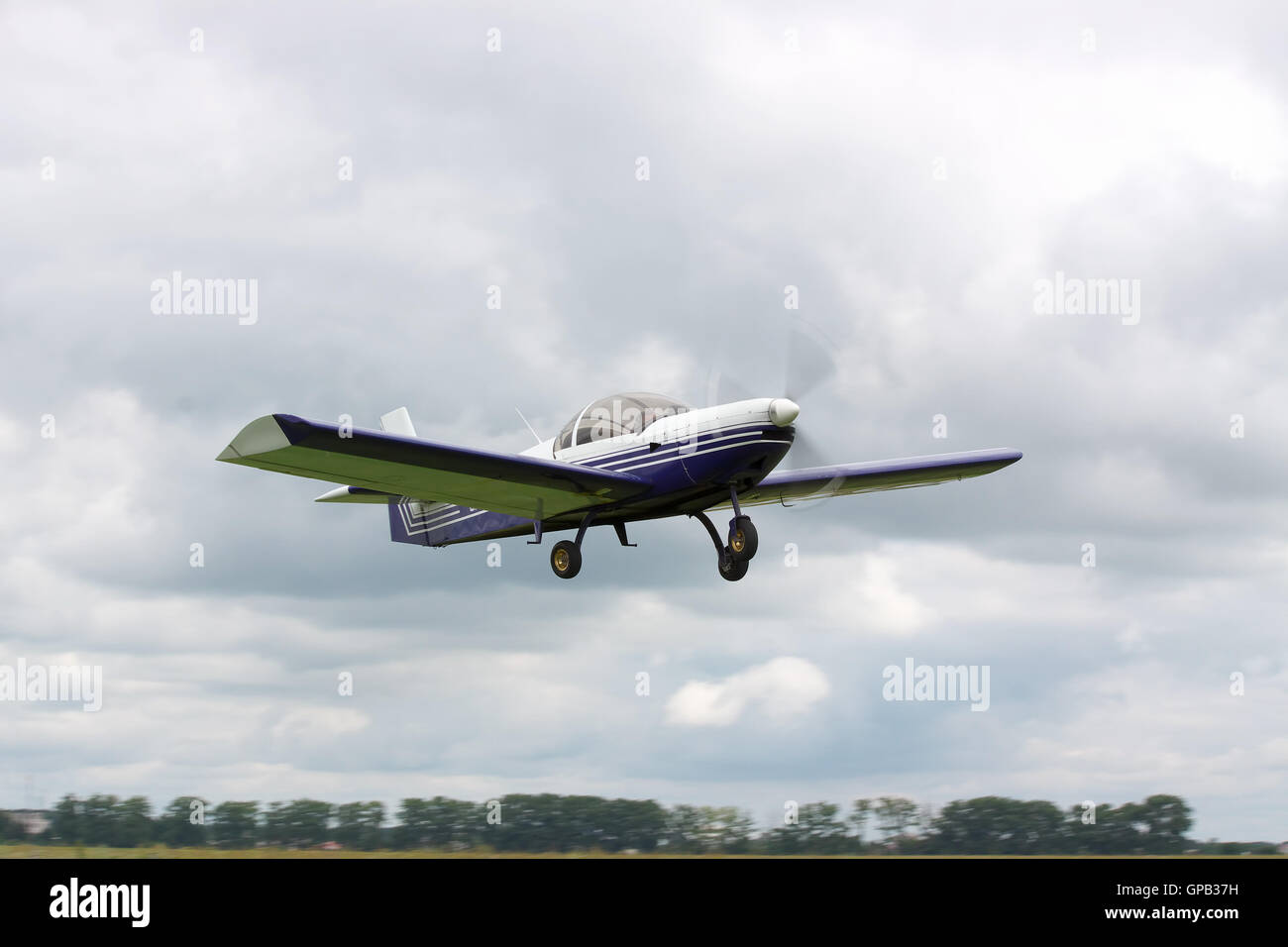 Small private plane is taking off into cloudy sky for a leisure flight ...