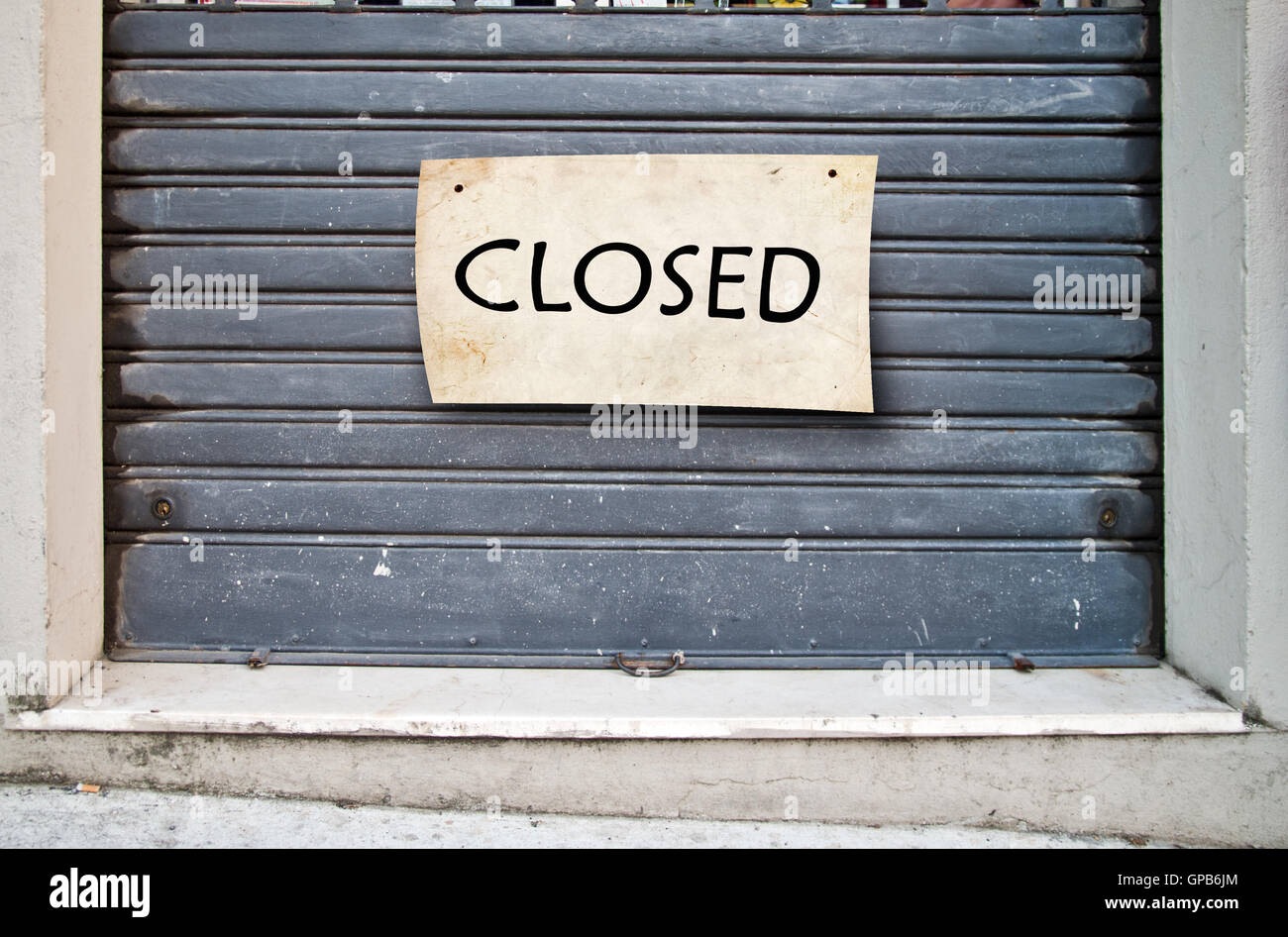 sad lowered shutter of a closed company Stock Photo - Alamy