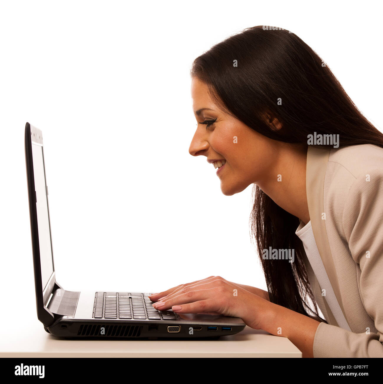 Excited woman looking into laptop computer Stock Photo - Alamy