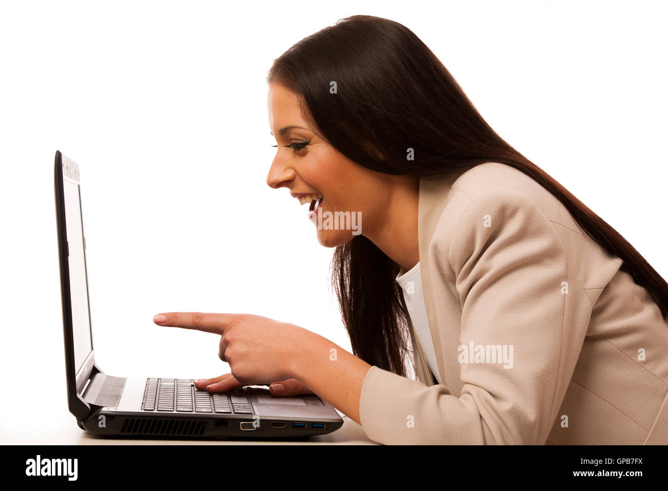 Excited woman looking into laptop computer pointing with finger on ...