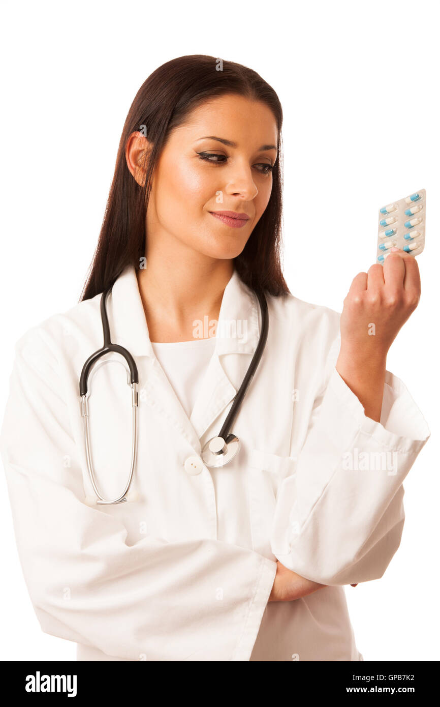 Woman doctor in uniform with stethoscope around neck holding pills cure ...