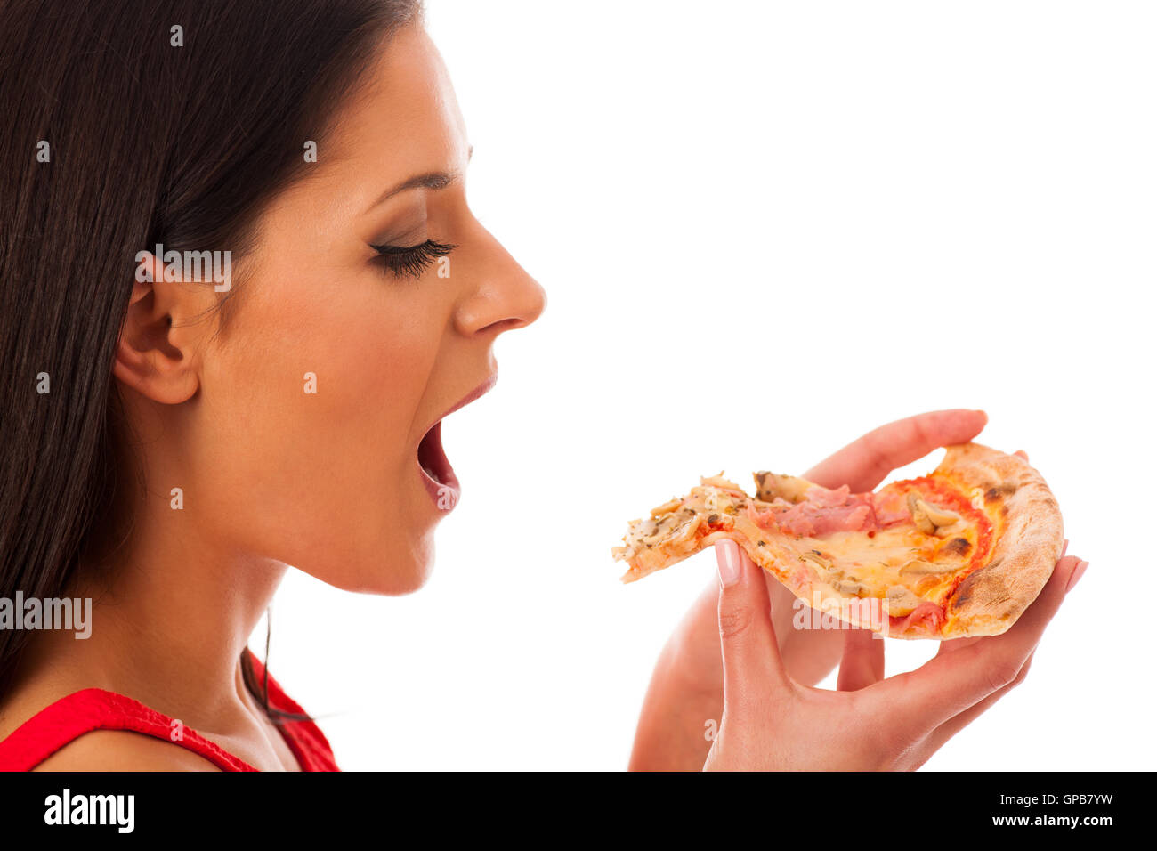 Young woman eating pizza isolated over white background Stock Photo - Alamy