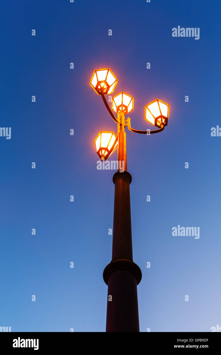 lightened old street lamp with blue night sky Stock Photo - Alamy