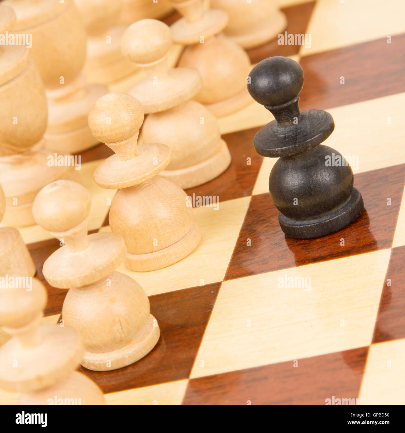 Black pawn on a wooden chessboard Stock Photo - Alamy