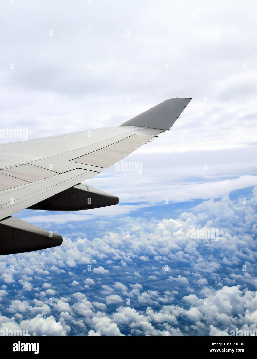 Earth and airplane wing viewing from a plane Stock Photo - Alamy