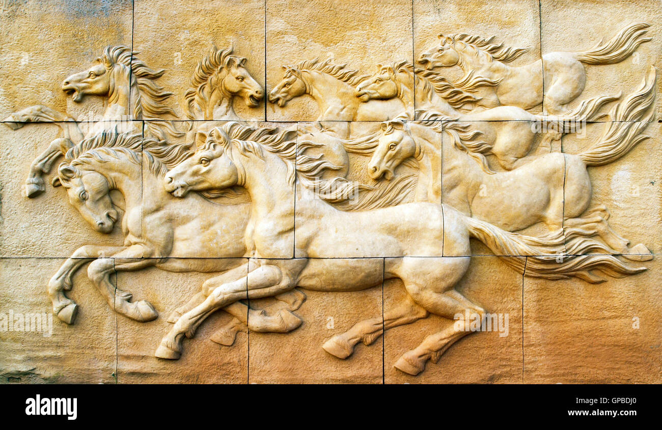 Stone sculpture of horse on wall Stock Photo - Alamy